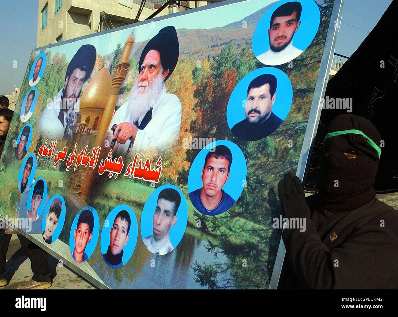 People carry a poster showing Shiite cleric Mohammed Sadiq al-Sadr ...