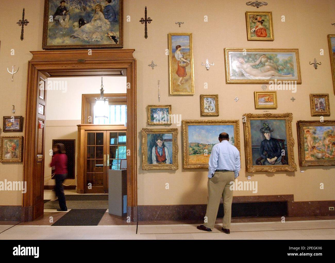 ** FILE ** A visitor looks at a painting during a tour for members of ...