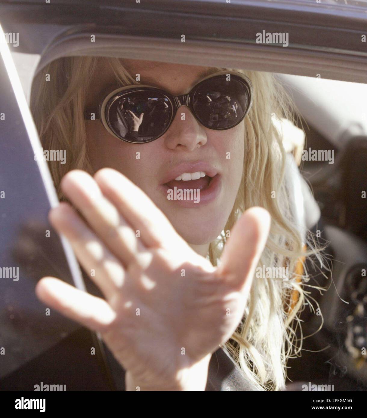 Singer Courtney Love, who is charged with felony drug possession, waves ...