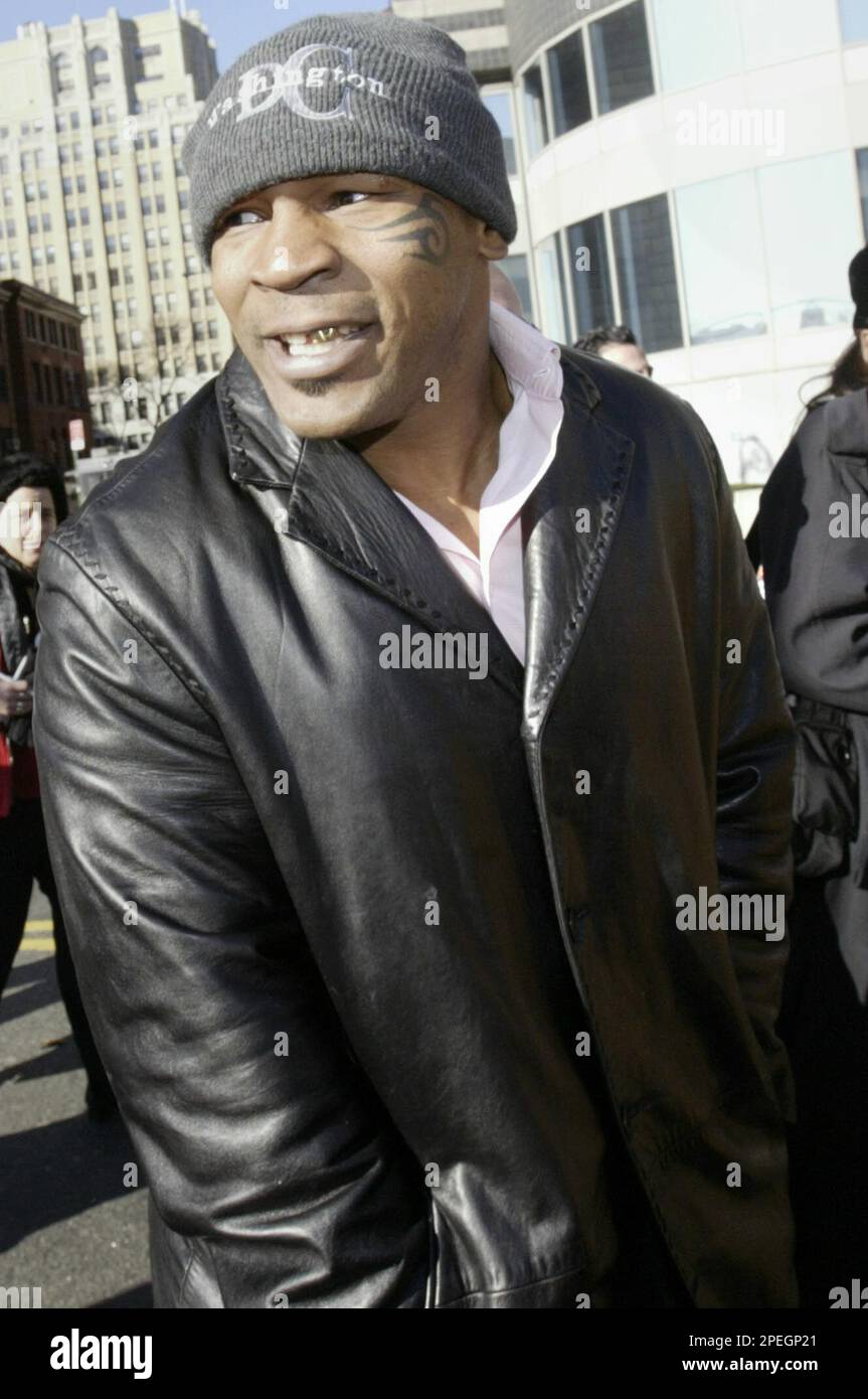 Heavyweight boxer Mike Tyson yells back to a fan after leaving a ...