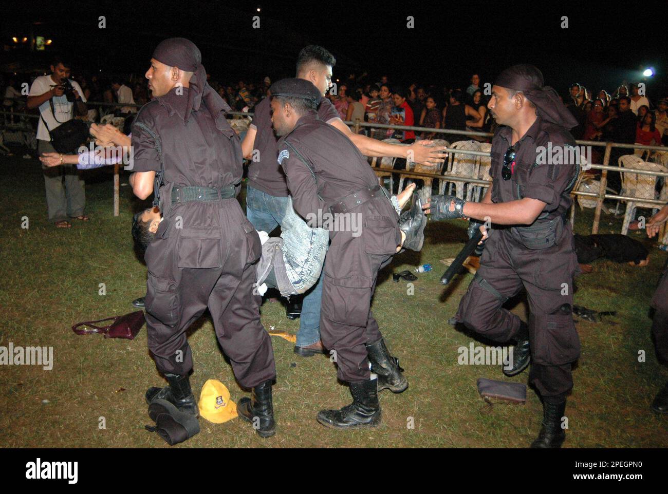 Elite security guards carry an injured from the site of an explosion ...