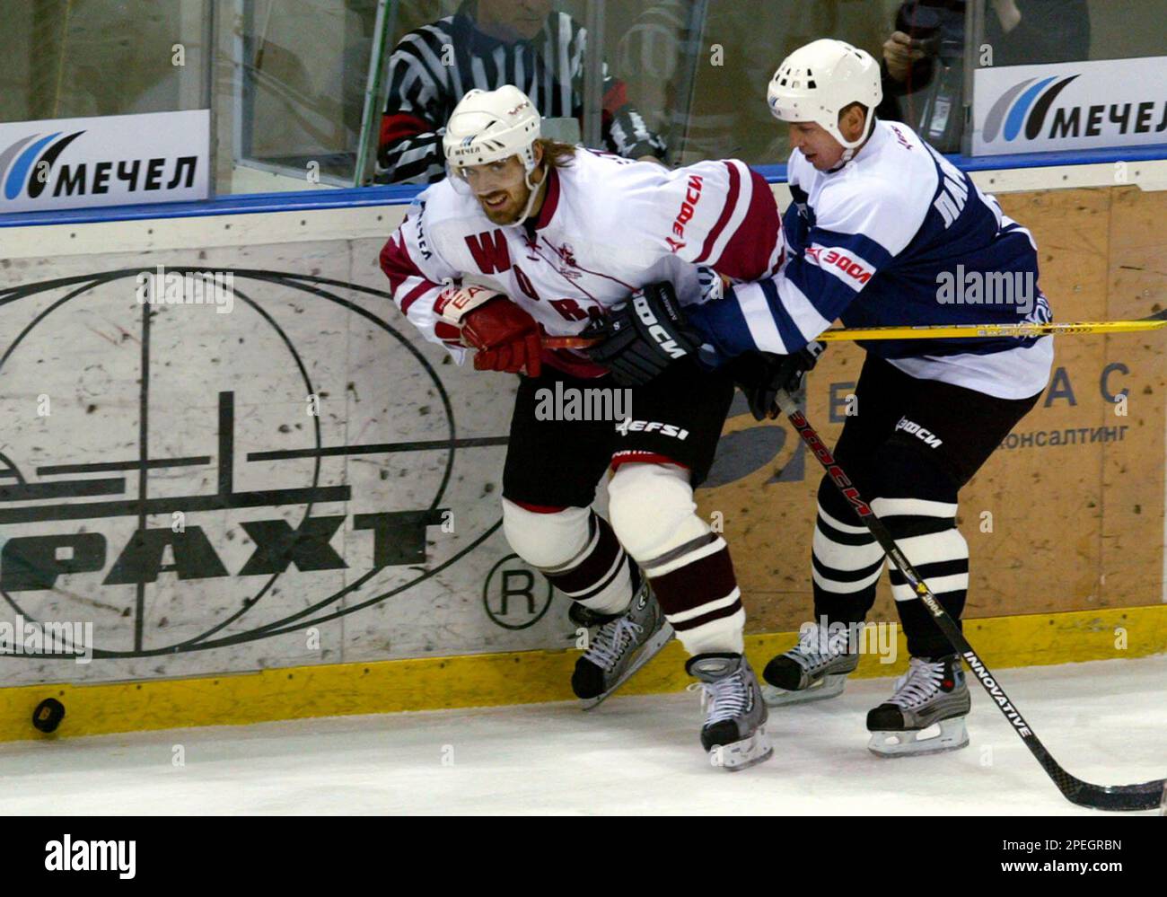 Team World's Tomas Holmstrom, left, and Team Russia's Igor Larionov ...