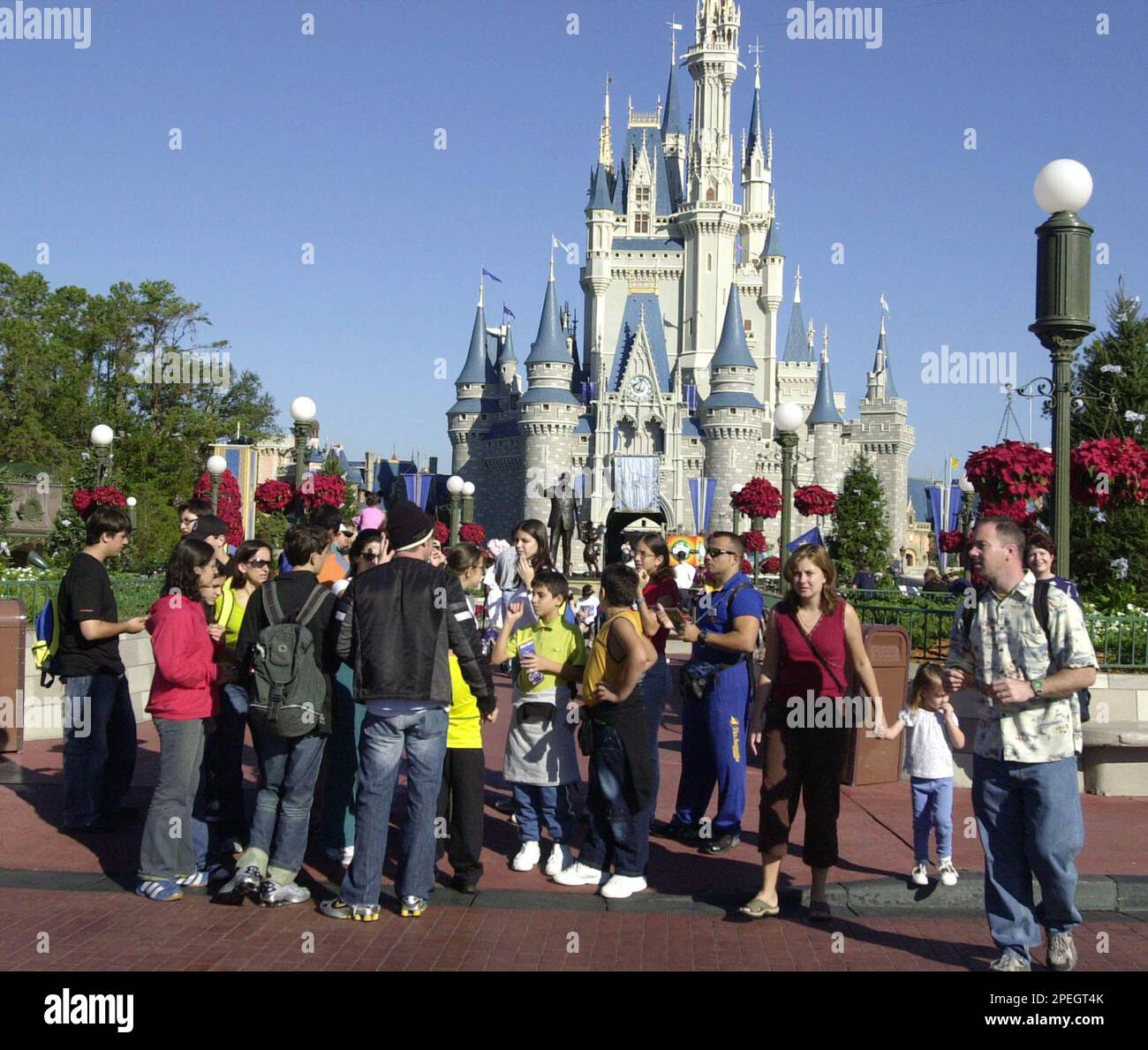 Visitors leave a show at Cinderella's Castle, rear, at the Magic ...