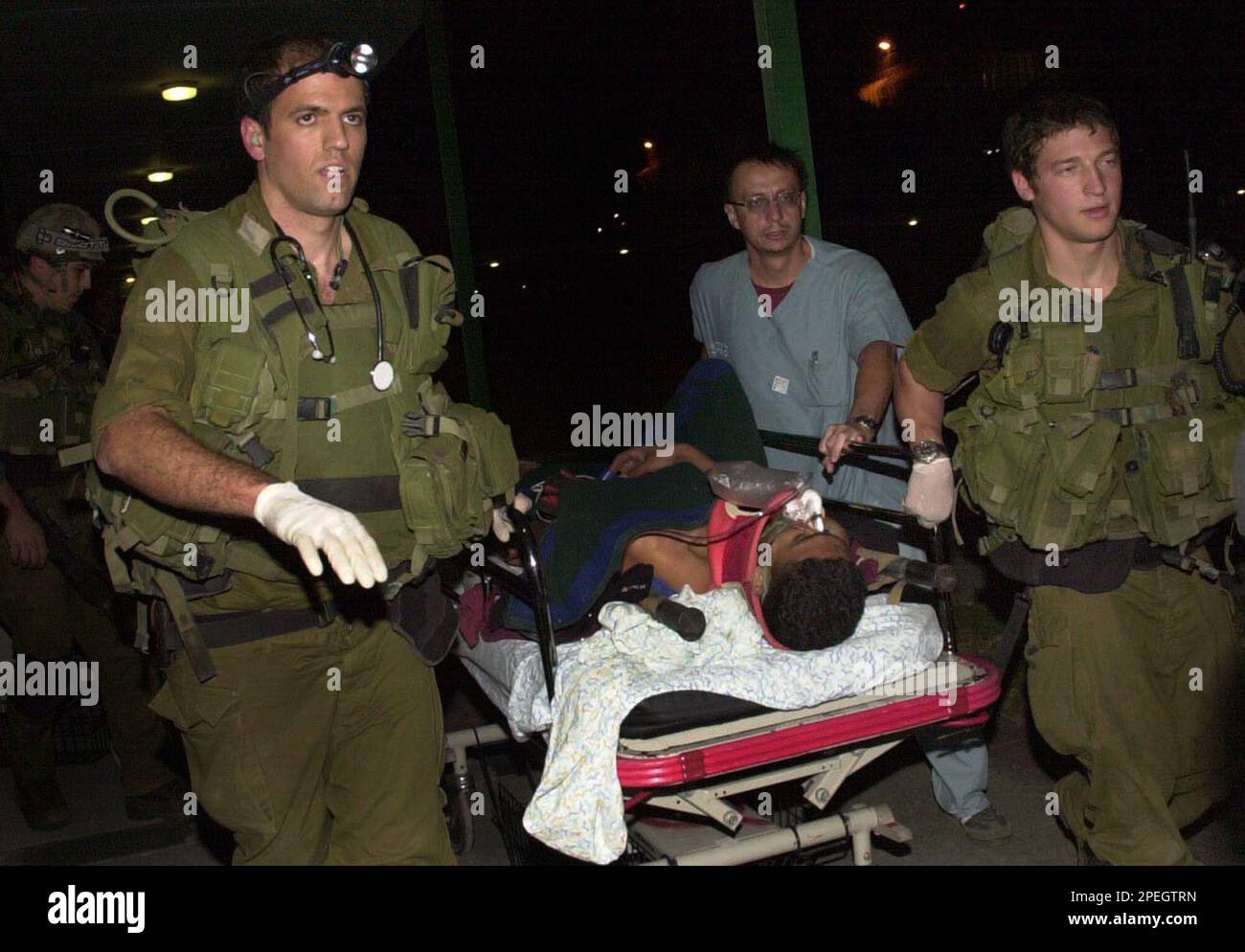 Israeli army medics carry a wounded Israeli soldier, who was injured ...