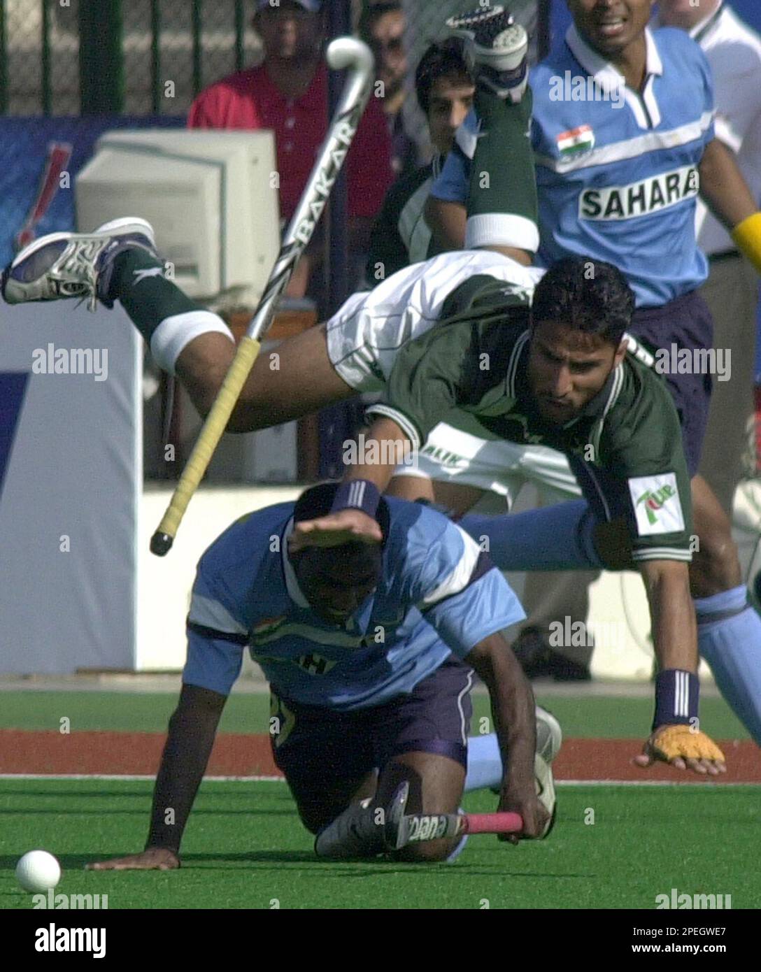 Pakistan's Shakil Abbasi jumps over Indian's Arjun Halappa during a ...