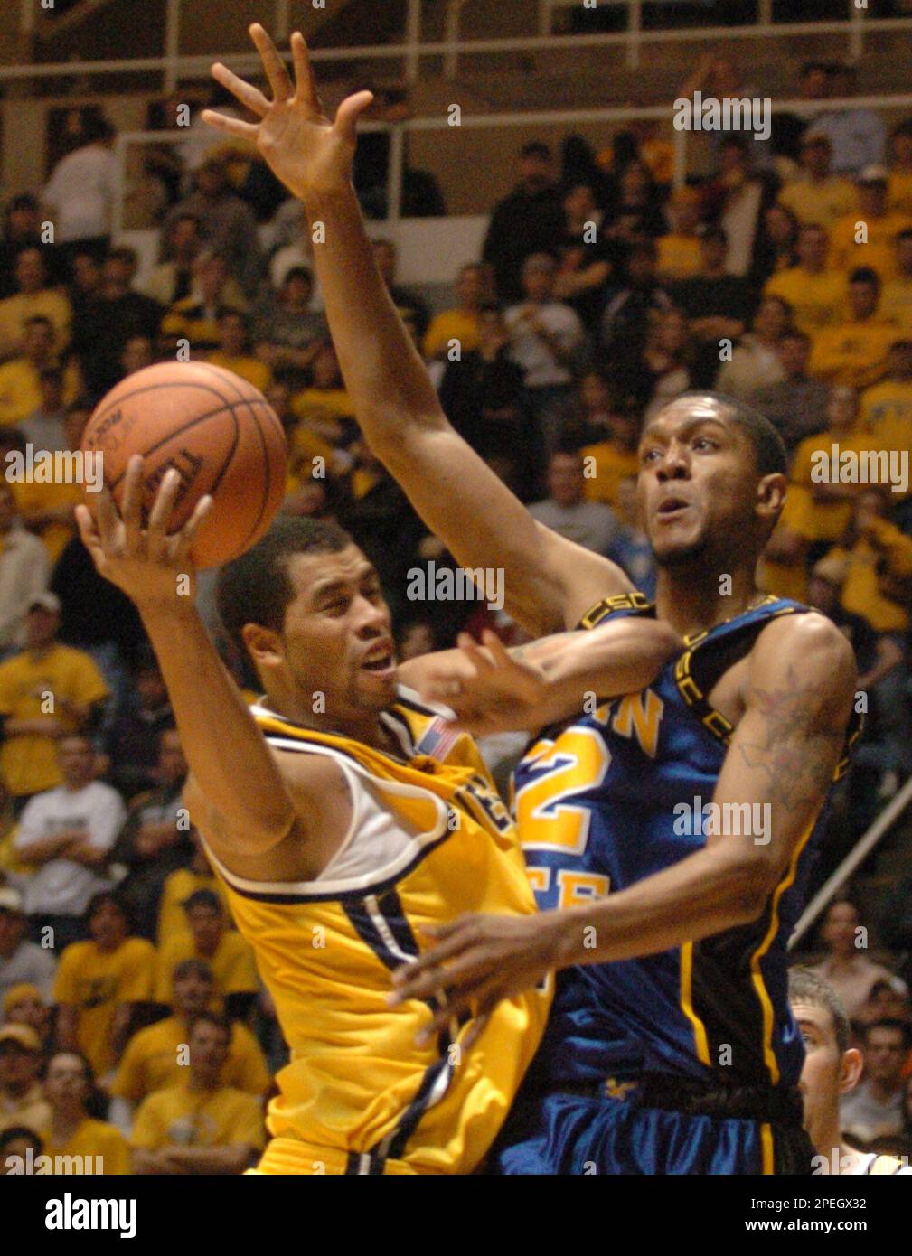 West Virginia forward Tyrone Sally, left, goes up for a shot around ...