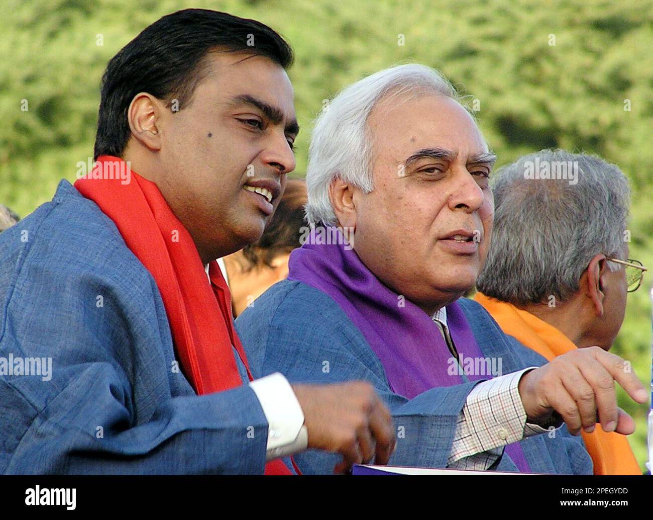 Mukesh Ambani,left, Chairman and Managing Director, Reliance Industries, talks to Kapil Sibal ...