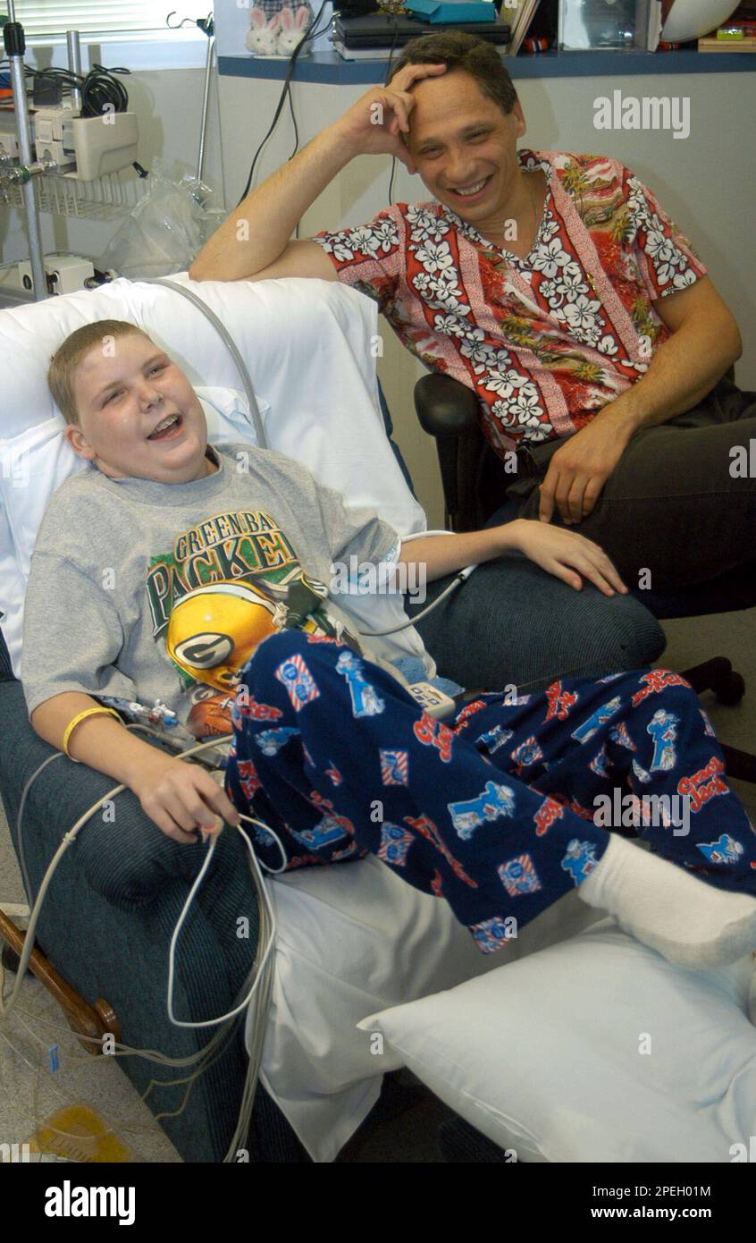 Travis Marcus of Cabot, Ark., left, jokes around with his heart doctor ...