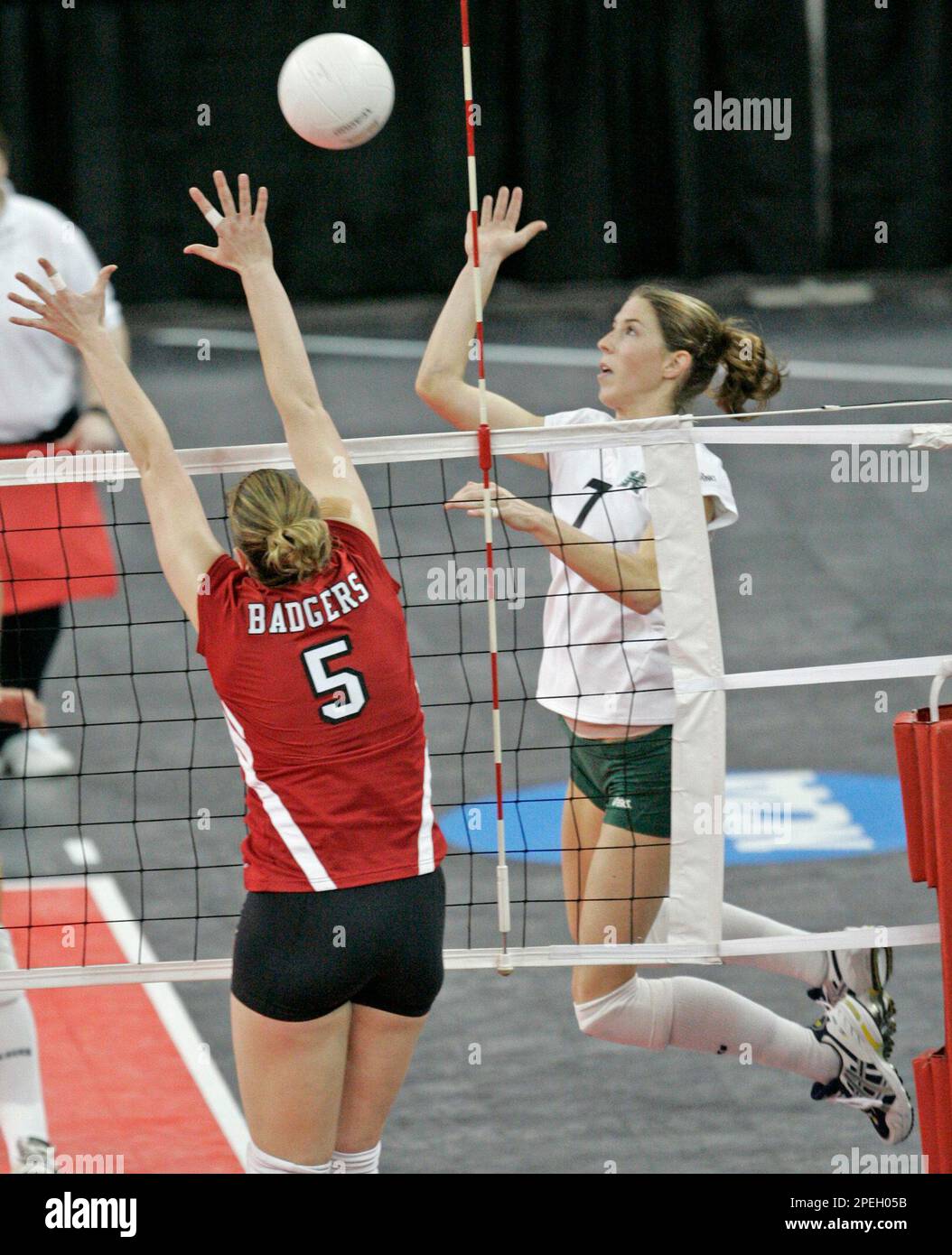 Hawaii's Alicia Arnott, right, tires to hit past the defense of ...