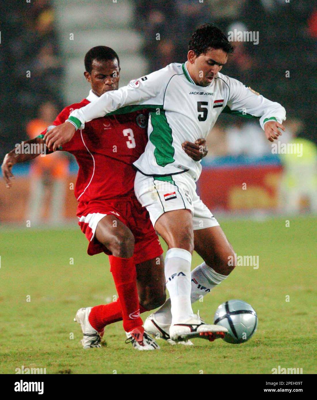 Oman's Juma Abulla, left, holds Iraq's Nashath Ali's advance during ...