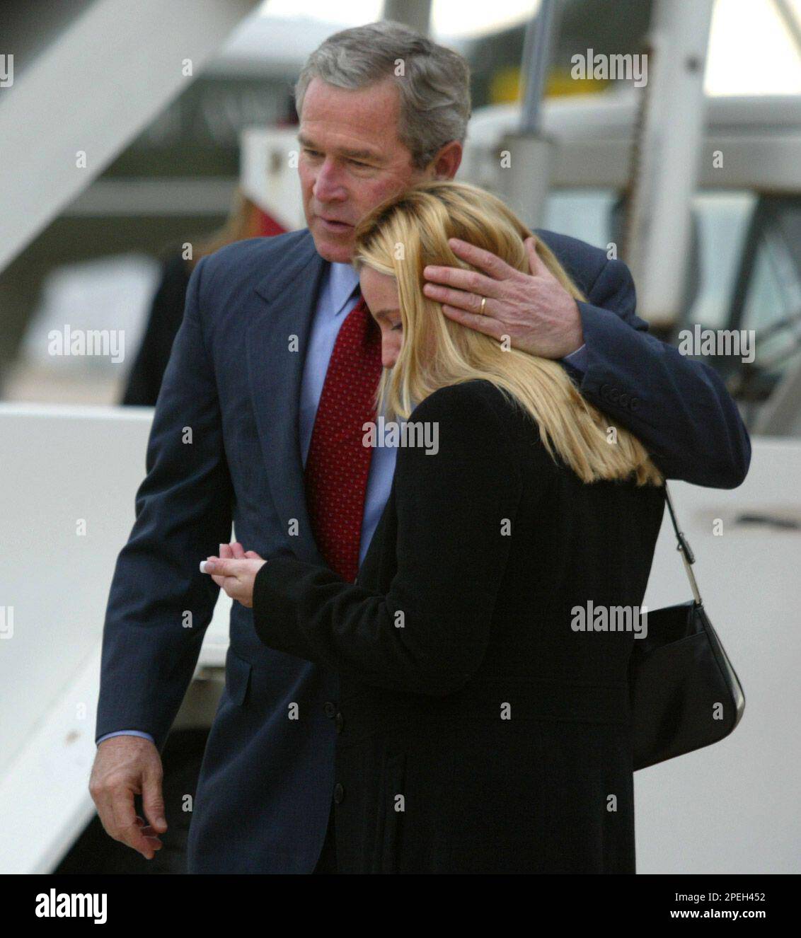 President Bush is greeted by Kathryn Gwen Ostapuk, as he arrives at the ...