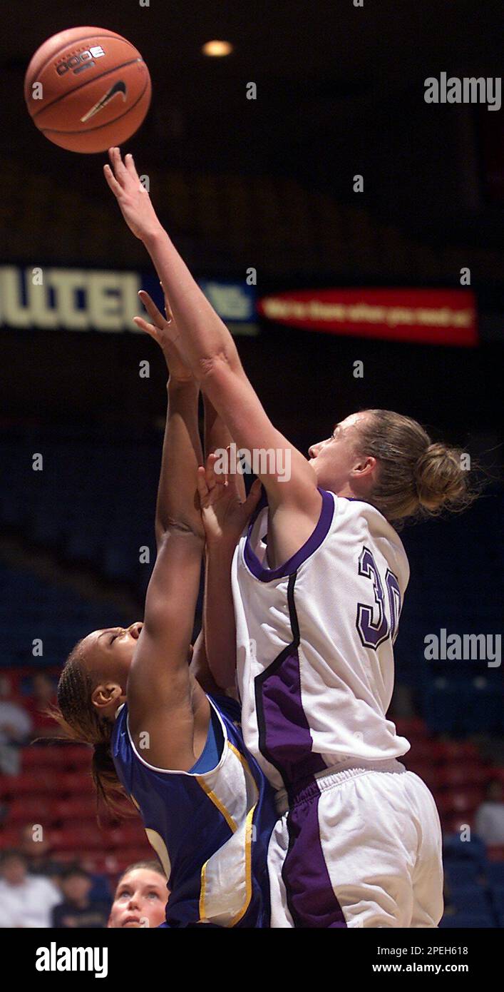 Weber State's Brooke Hansen right, shoots over the outstretched hands ...