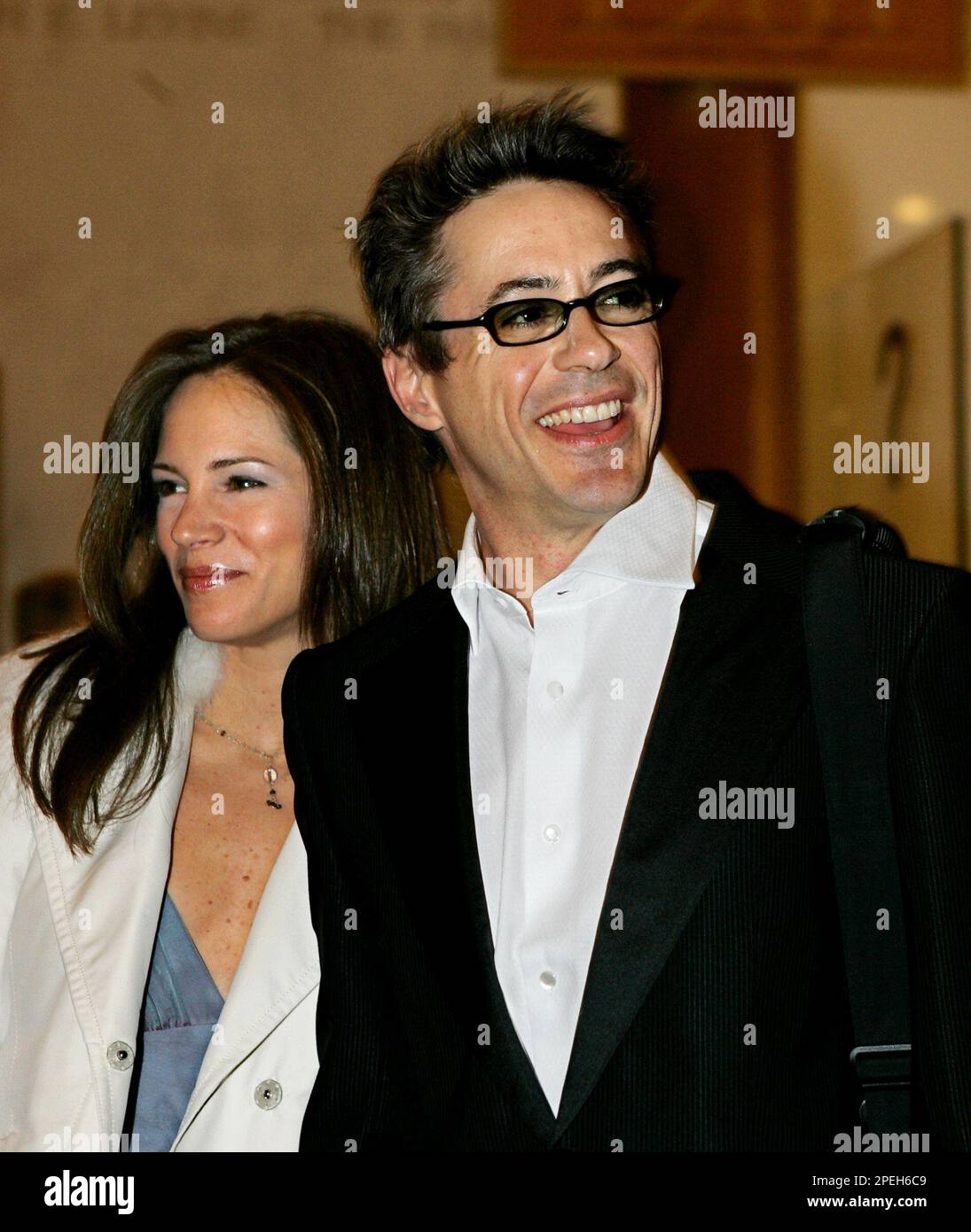 Actor and singer Robert Downey Jr., with Susan Levin, left, arrives for ...