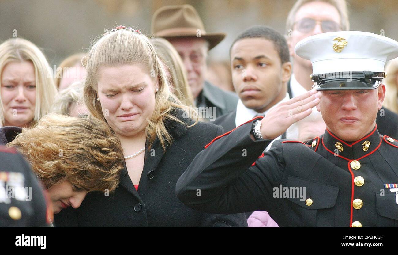 Childhood friend, Lance Cpl. George Kalantzis, right, and widow Ashley Brooks fight back tears ...