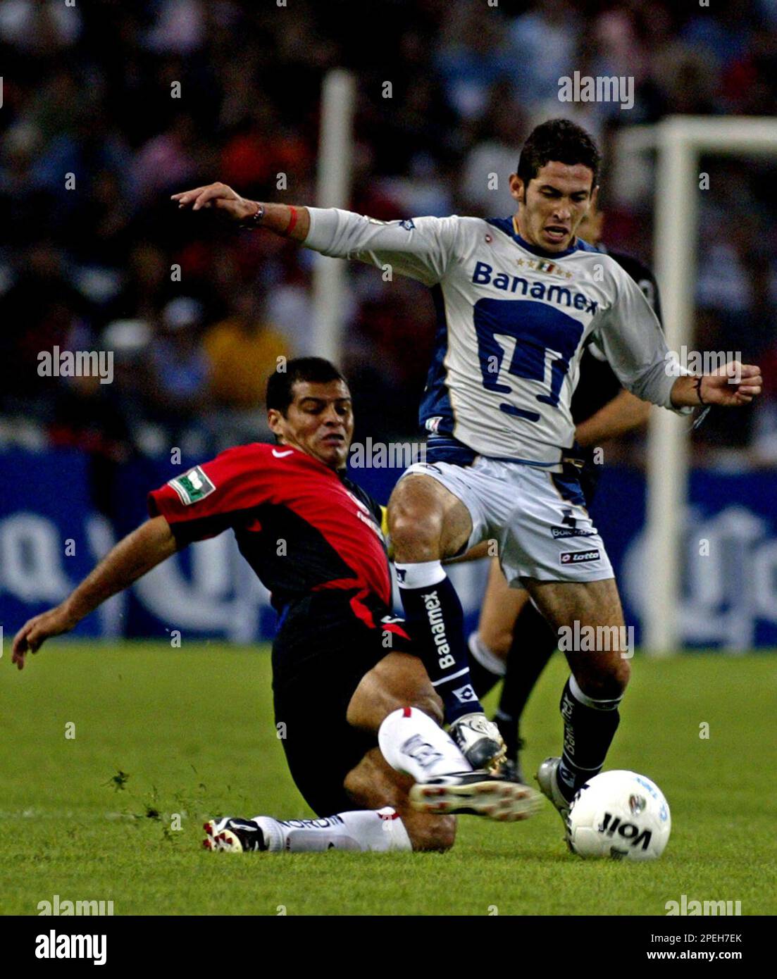 Pumas' soccer player Jaime Lozano, top, fight for the ball with Atlas ...