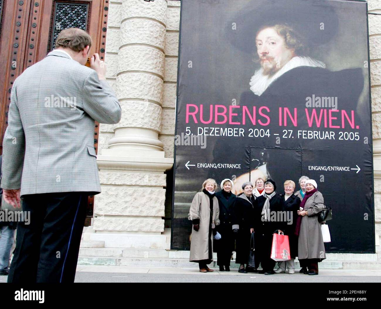 A Visitor take a photo of a group in front of a Rubens poster brfore ...