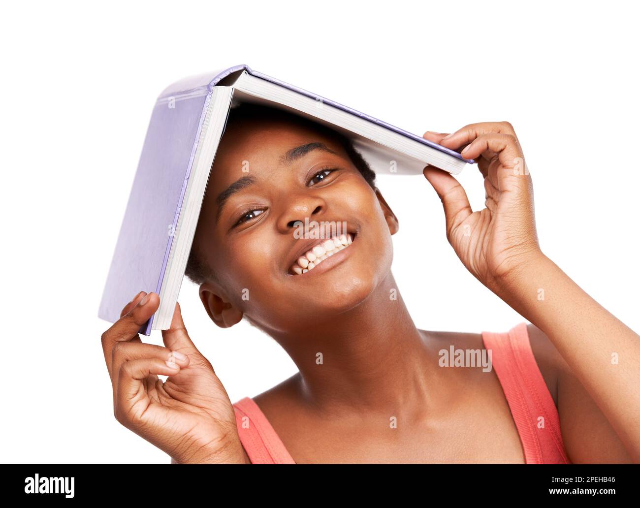 Books have many uses. Studio portrait of a young african girl balancing ...
