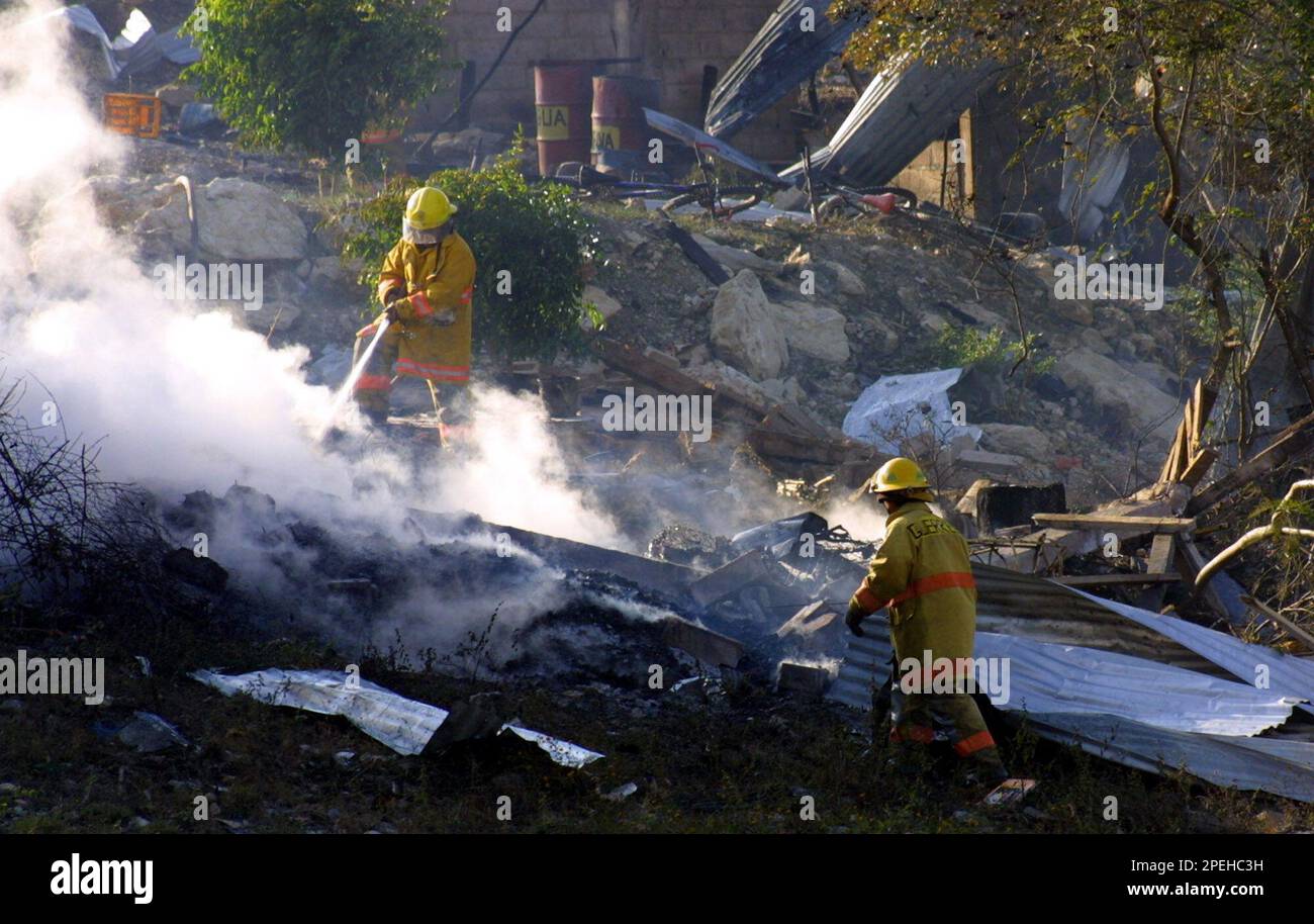 Firefighters douse the remains of a fireworks factory that exploded ...