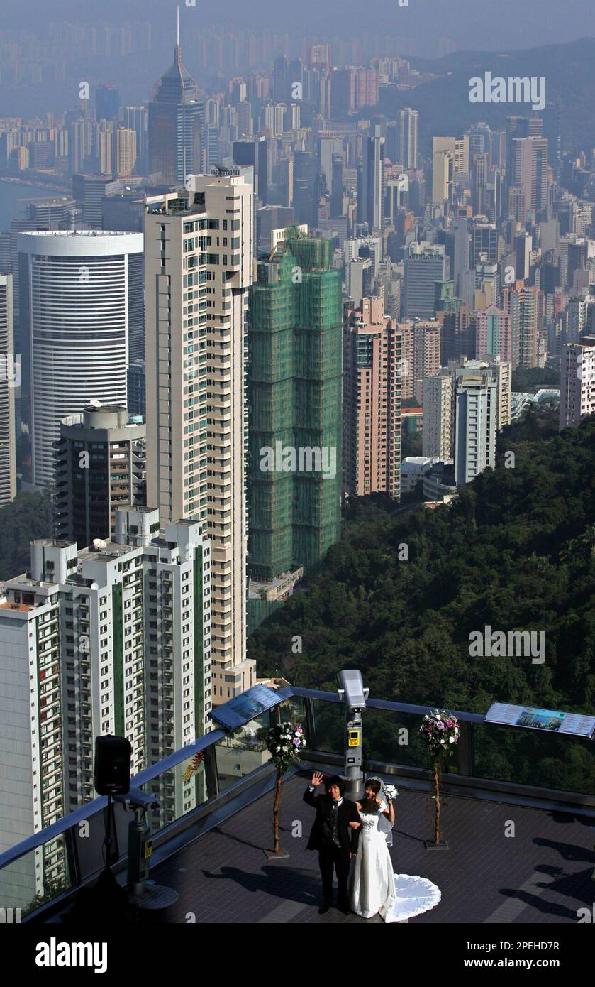 A Japanese couple Ryuichi Amano and Miho Ogawa wave at Hong Kong's ...