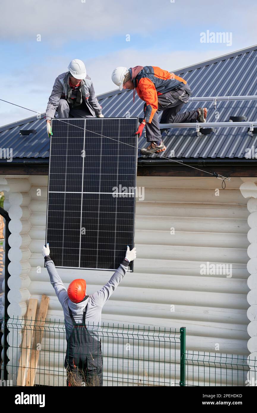Male technicians installing solar cell hi-res stock photography and ...