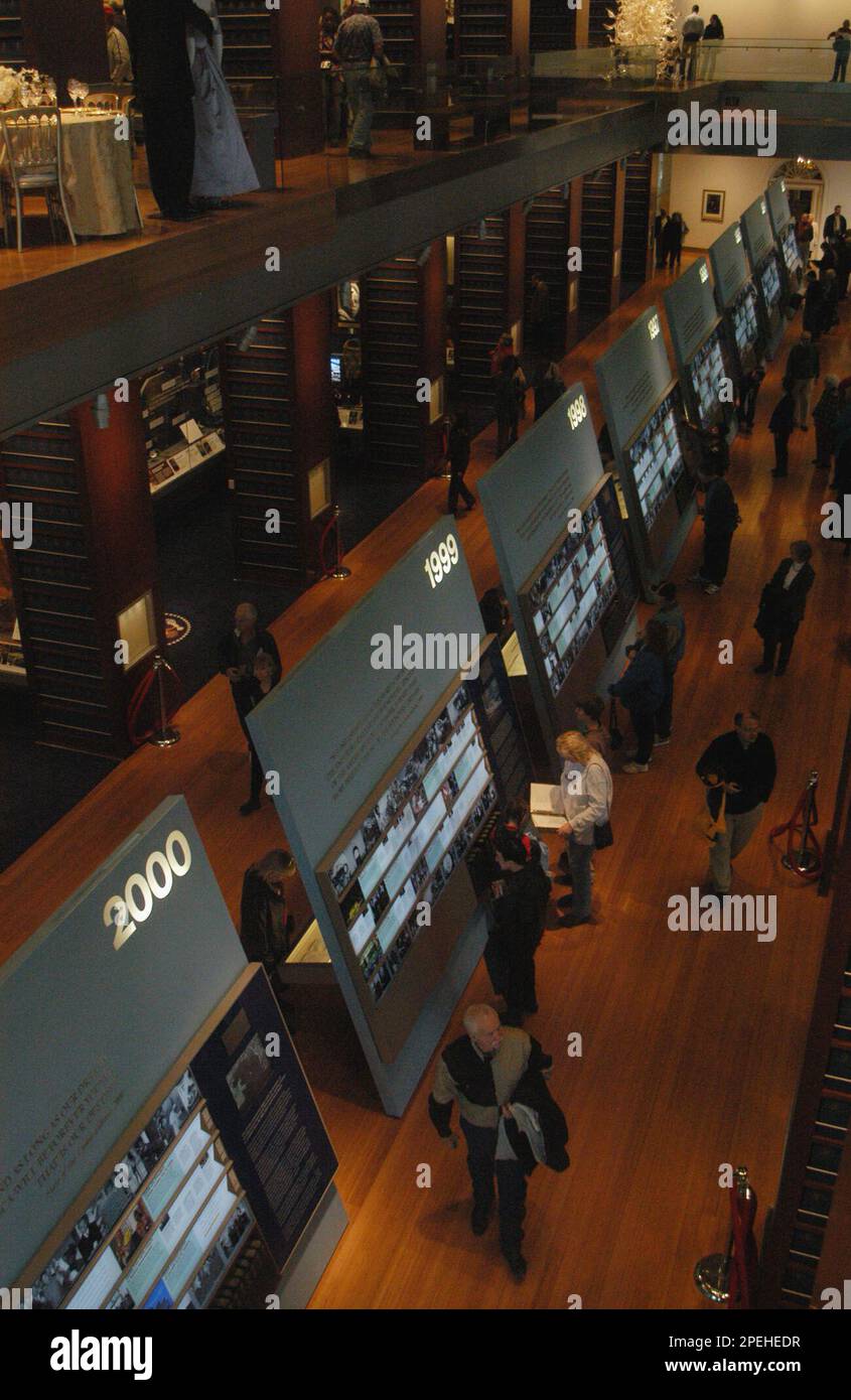 A group of people tour the inside of the Clinton Presidential Library ...