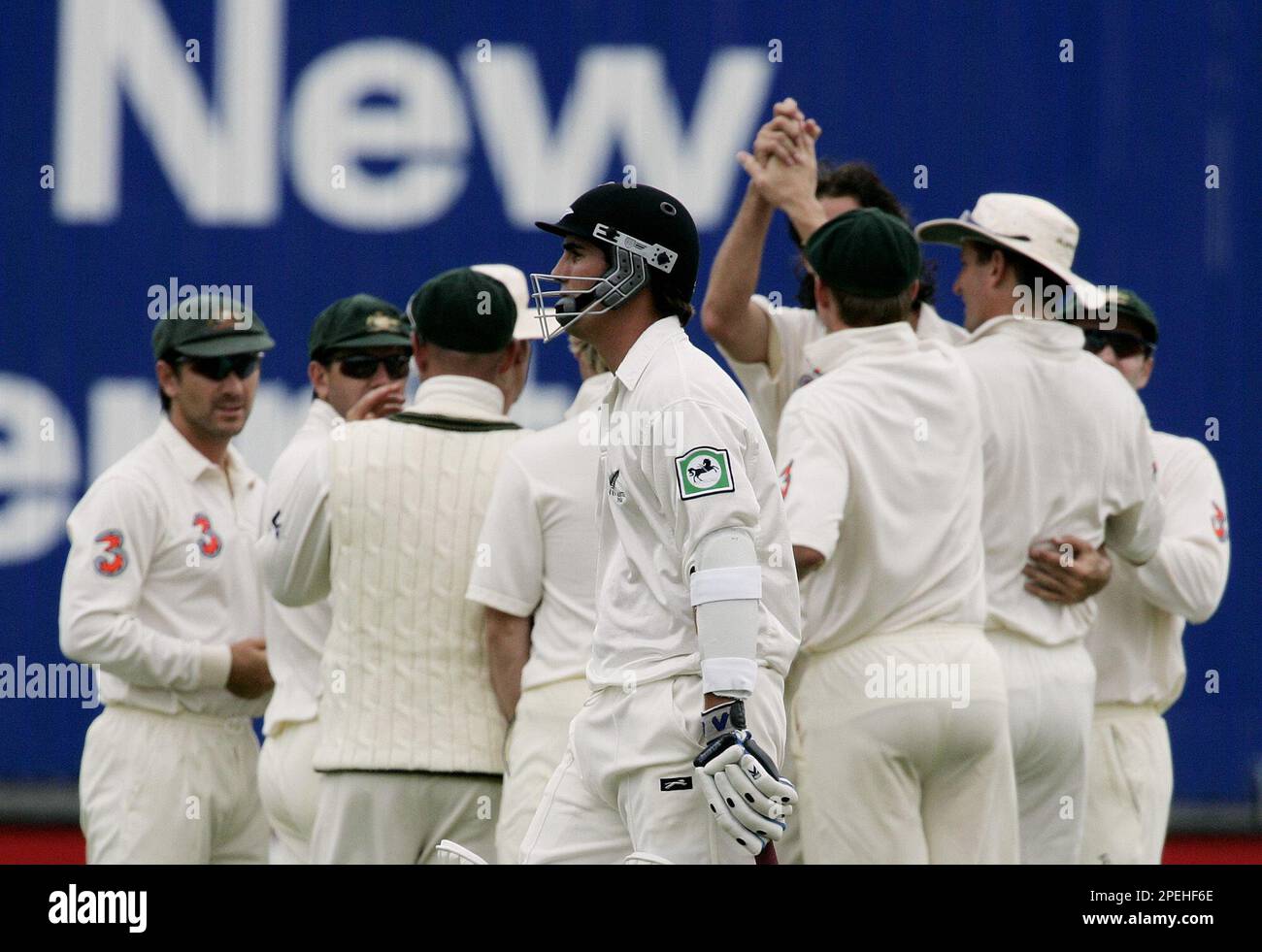 New Zealand's batsman Matthew Sinclair, center, walks from the field as ...