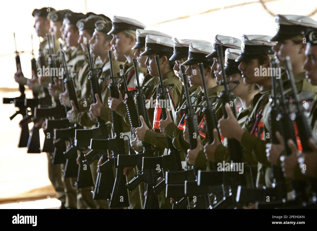 Israeli army officers, members of an honour guard, present their ...