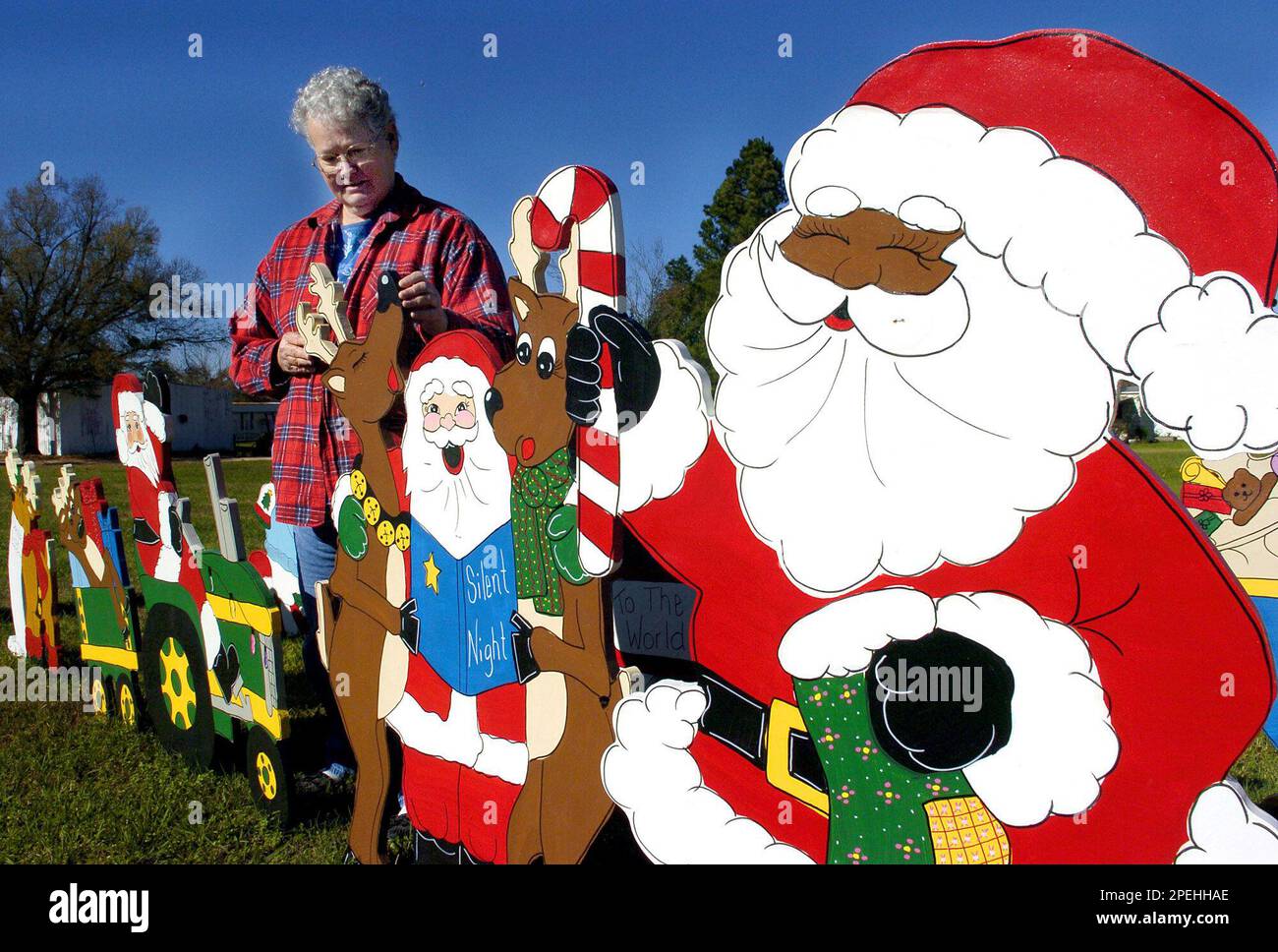 Mary Crouch puts the finishing touches on her Christmas character cut ...