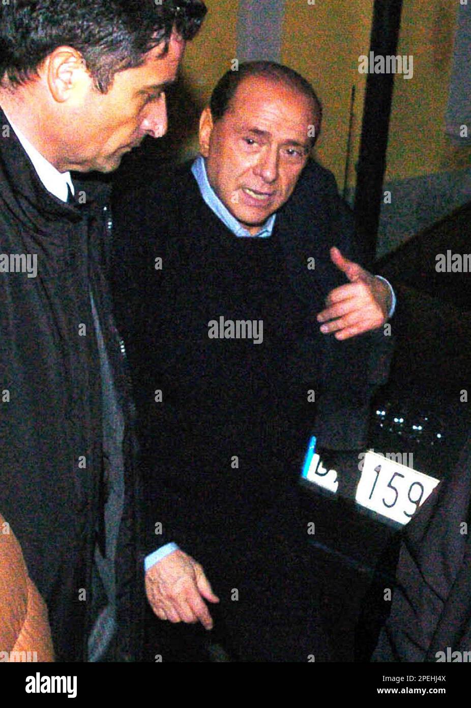 Italian premier Silvio Berlusconi, center, leaves the house of Northern ...