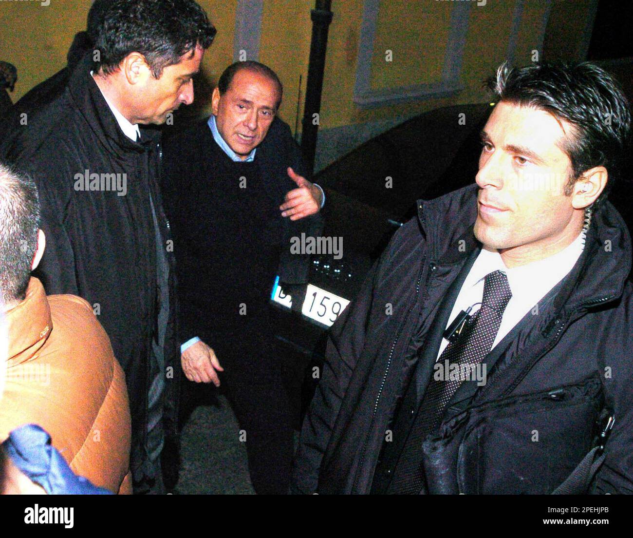 Italian premier Silvio Berlusconi, center, leaves the house of Northern ...