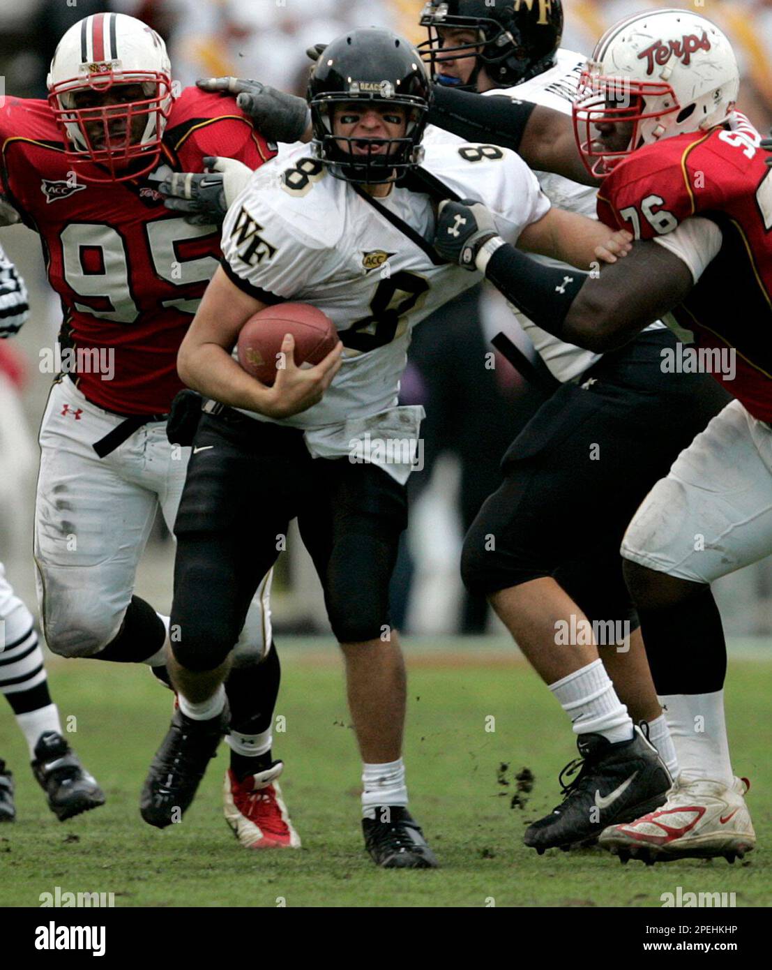 Wake Forest quarterback Ben Mauk, center, is taken down by Maryland's ...