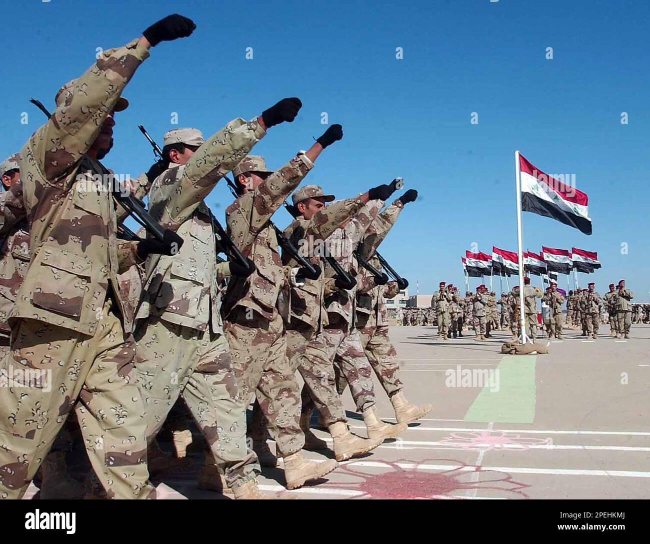 Members of the new Iraqi army parade past Iraqi flags at the Al ...