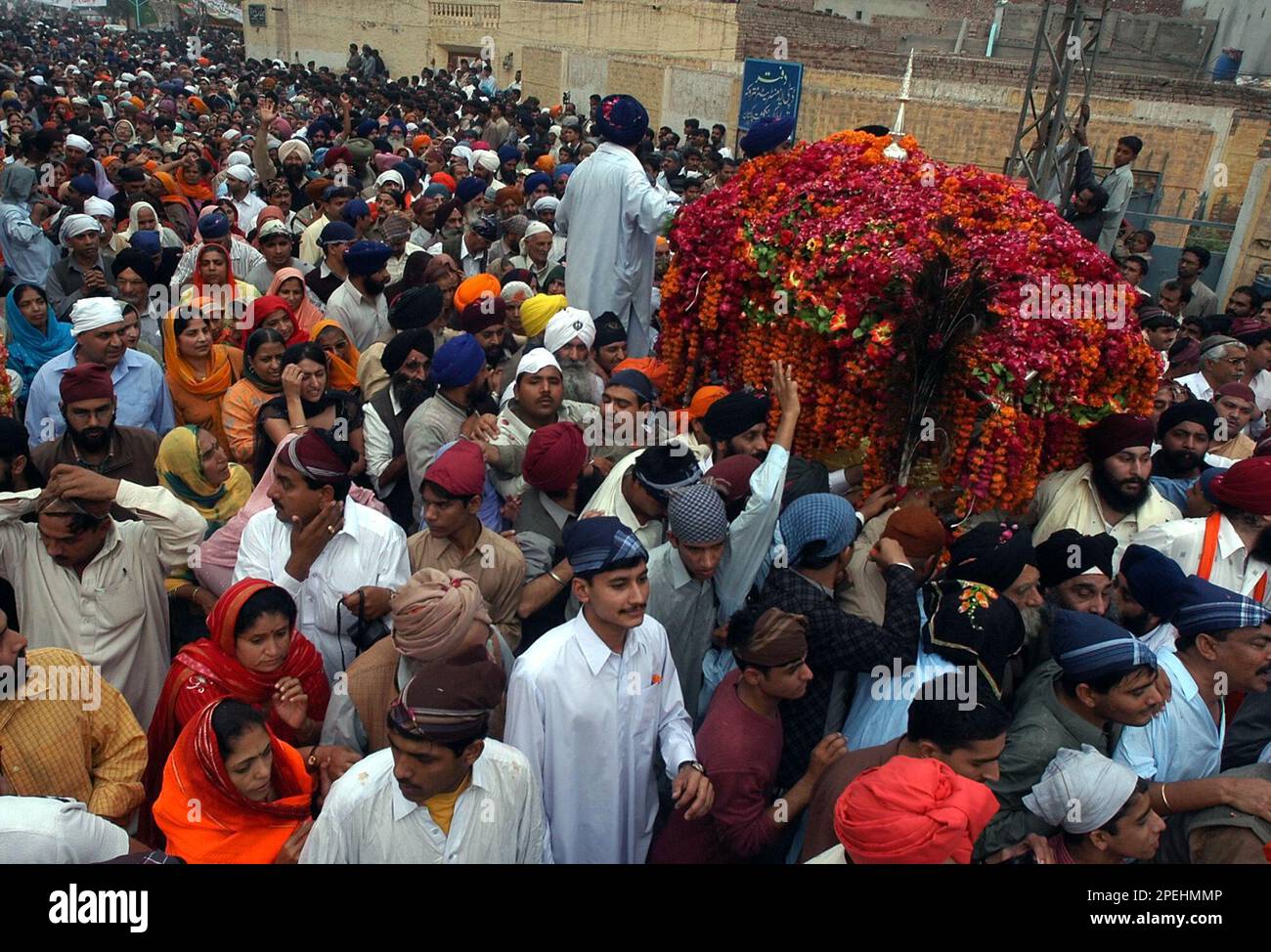 Sikh pilgrims bring Palkee, bunch of flowers, to pay homage to their ...