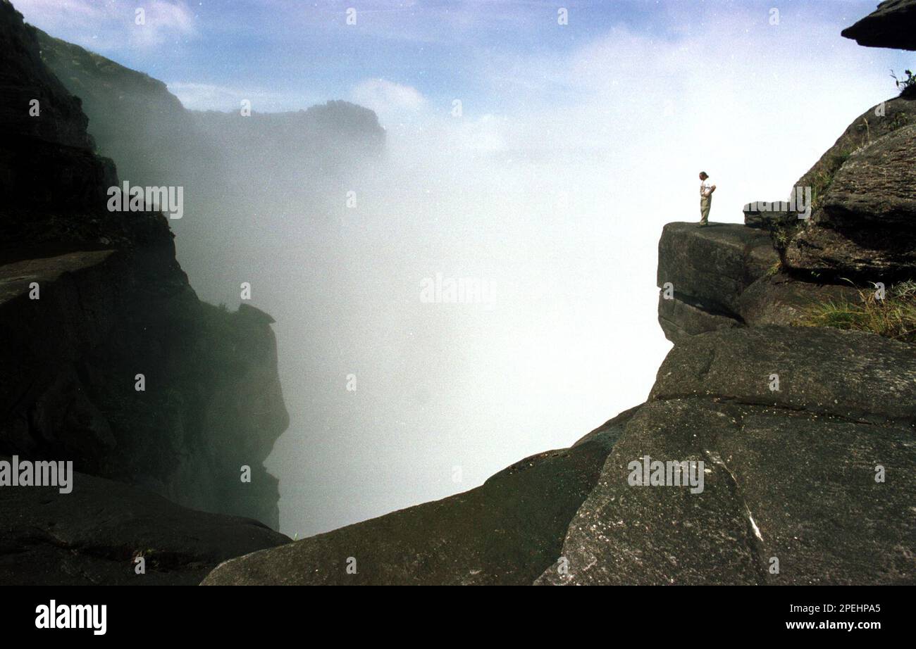 Tour guide Mario Rojas looks over an edge of Roraima tepuy called "the ...