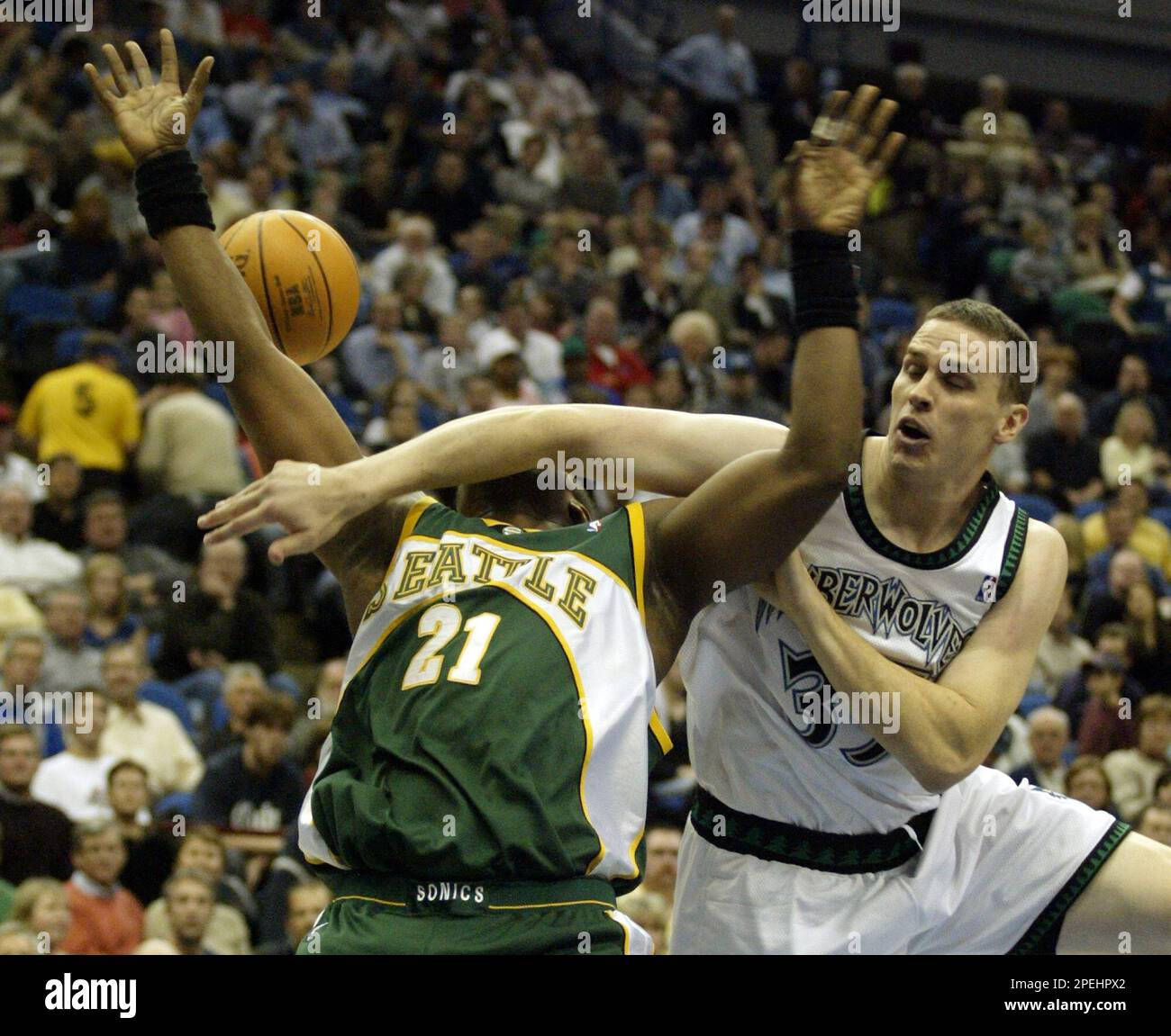 Seattle Supersonics' Danny Fortson (21) is fouled hard by Minnesota ...