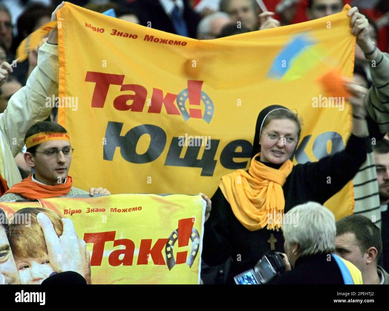 Pilgrims from Ukraine wave blue-and-yellow Ukrainian flags and the ...