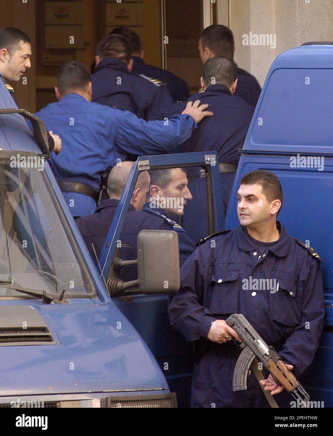 Montenegrin police officers escort to the court Damir Mandic, (unseen ...