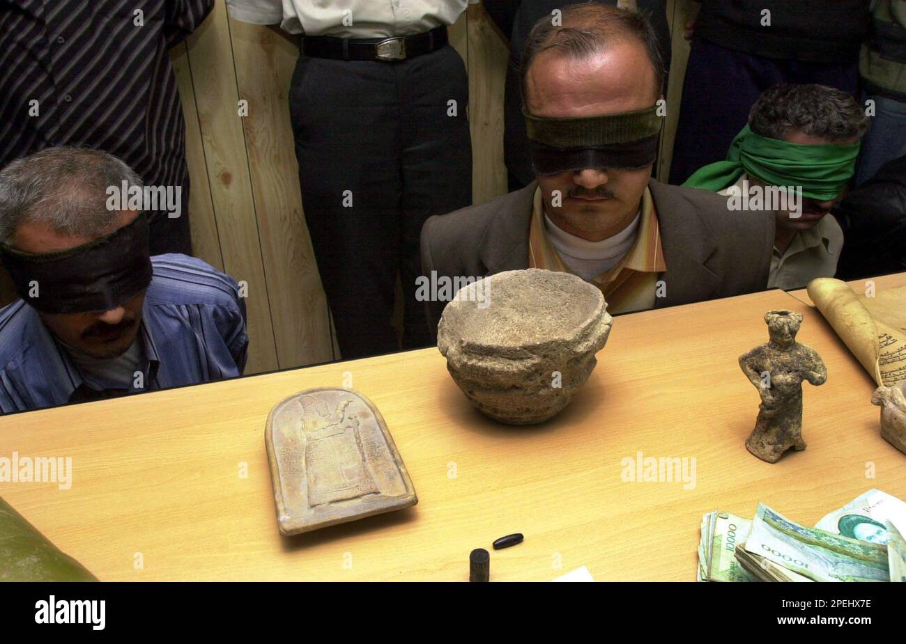 A group of Iranian men accused of being smugglers, who are bound and ...