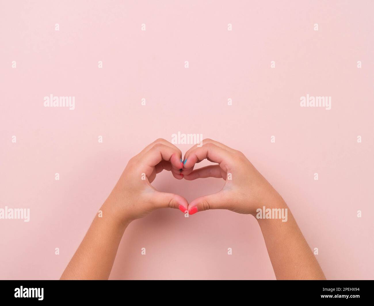 Girl hand showing heart shape, love and sympathy symbol on pink ...