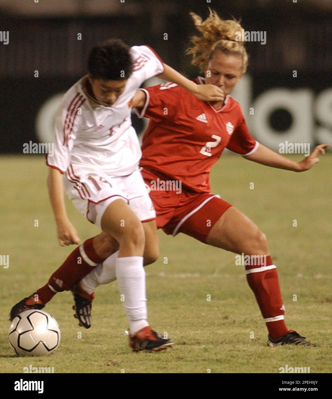 Lou Xiaoxu of China, left, and Katie Radchuck of Canada fight for the ...