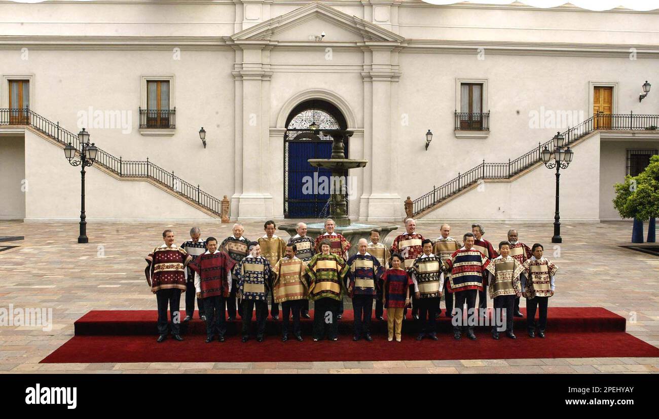 APEC leaders pose for photographers during their group photo at the ...