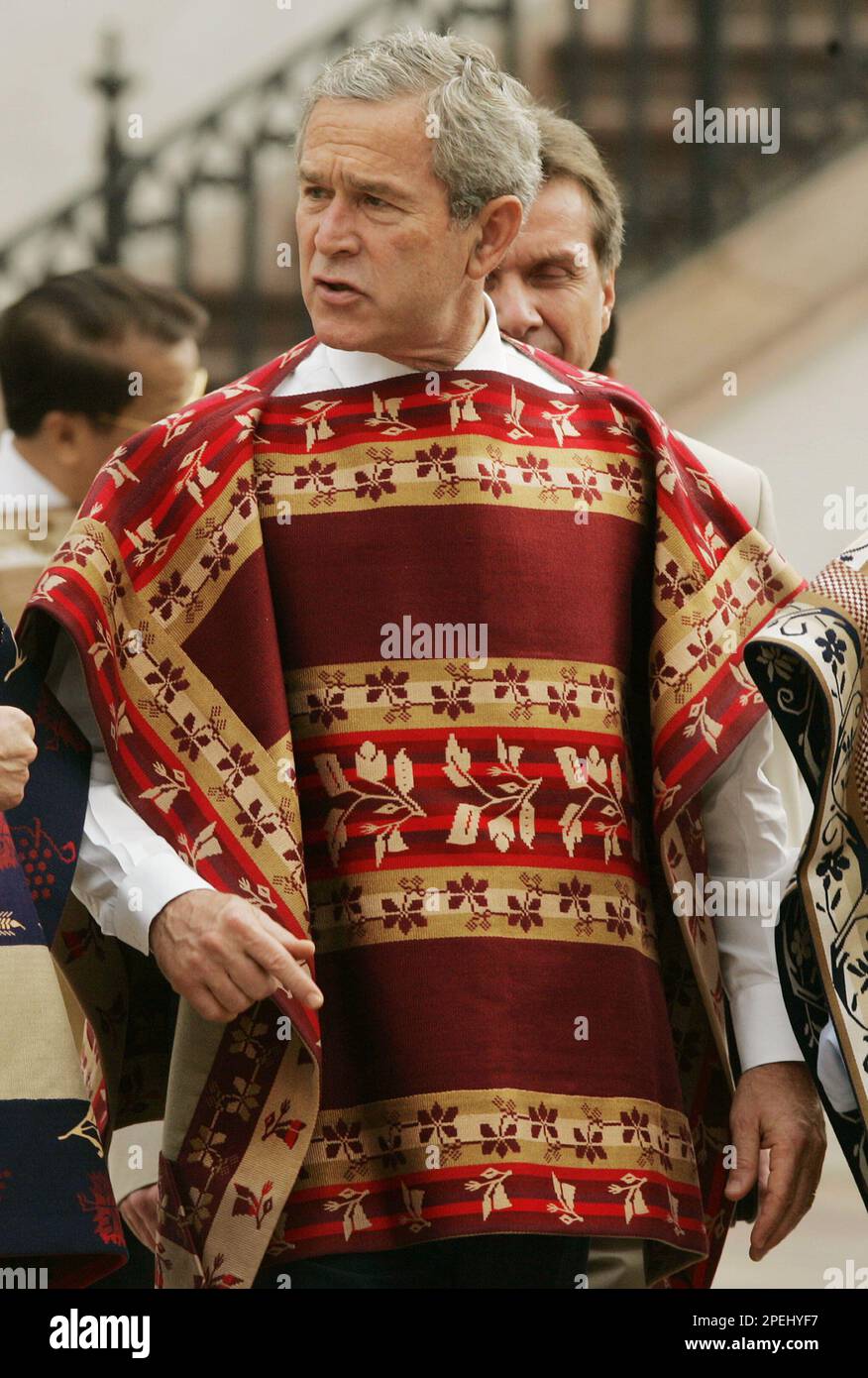 U.S. President Bush, wearing a traditional handmade Chilean poncho ...