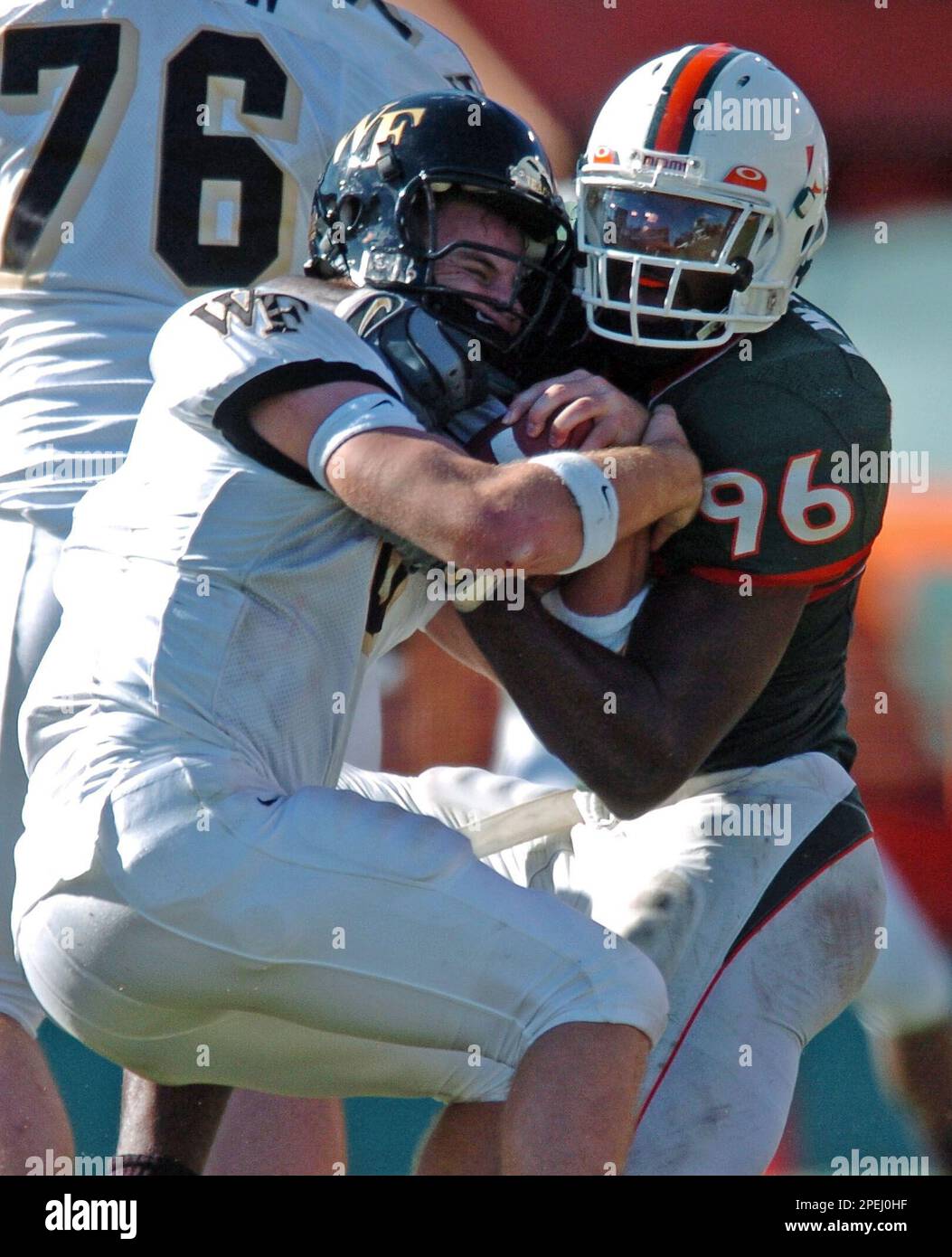 Wake Forest quarterback Ben Mauk (8) is sacked by Miam's Alton Wright ...