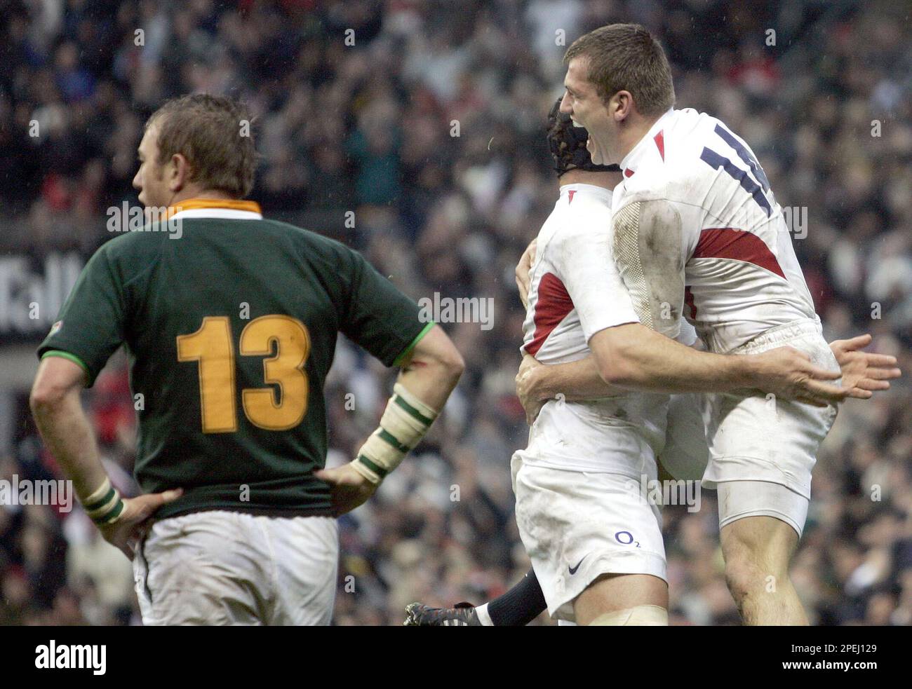 England's Mark Cueto, right, celebrates after scoring as South Africa's ...