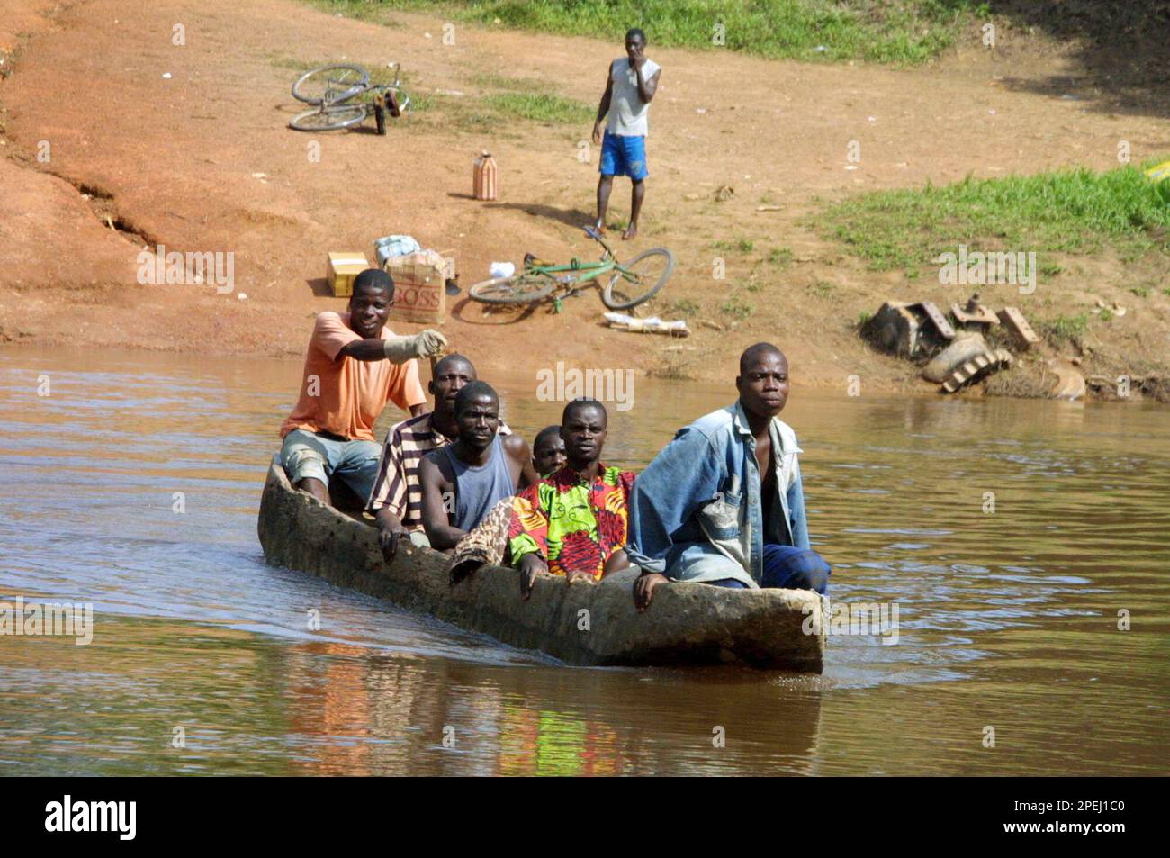 Ivorian refugees cross the Cestos river into the Liberian border town ...