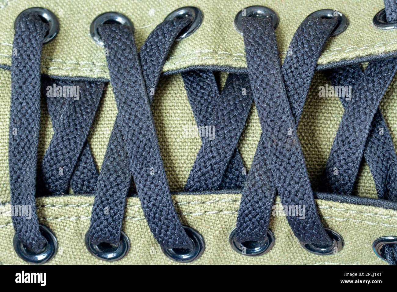Closeup of crossed black shoelaces on a sneaker Stock Photo - Alamy