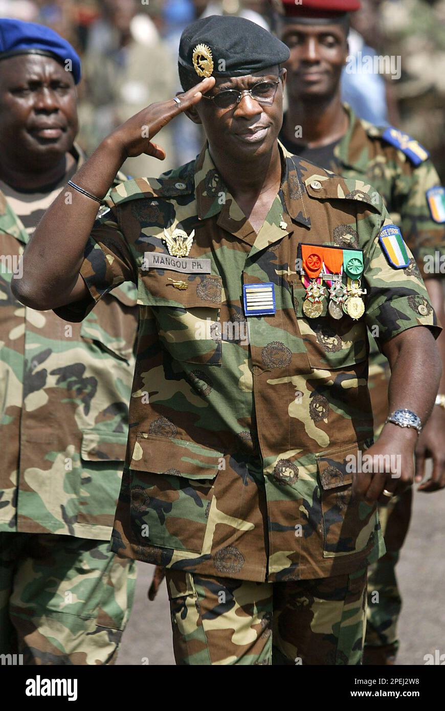 Colonel Mayor Philippe Mangou salutes his troops at the Ivory Coast ...