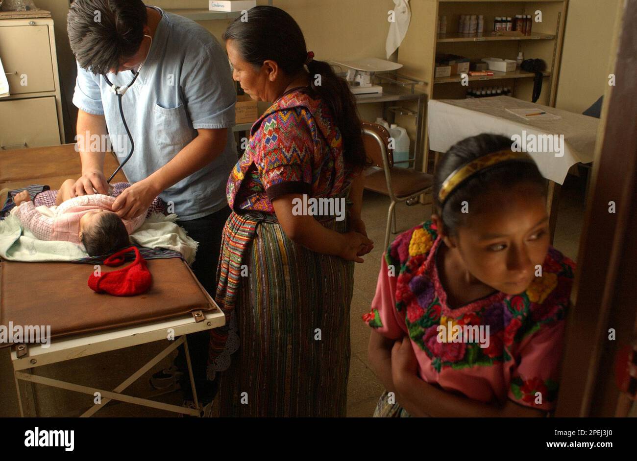 A doctor checks Victoria's respiration during a medical examination in ...