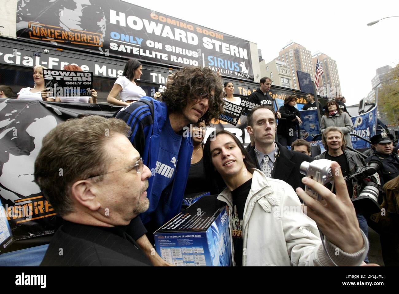 Radio host Howard Stern, center, poses for a picture with a fan as ...