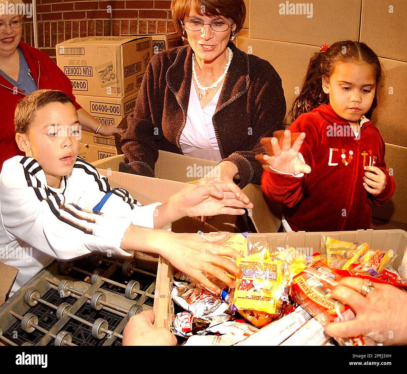 Dezmond Chafin, 8, and Malaya Chafin, 5, join their grandmother, Karen ...